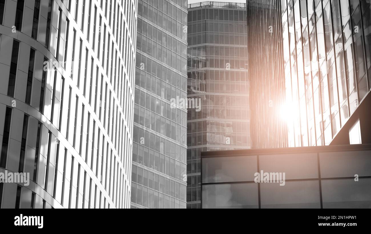 Bottom view of modern skyscraper in business district against blue sky ...