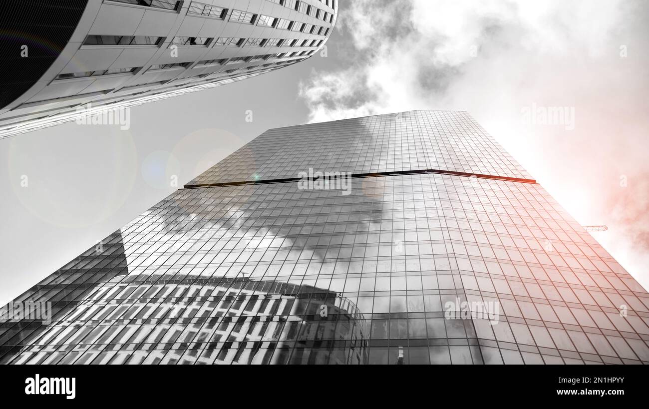 Bottom view of modern skyscraper in business district against blue sky ...