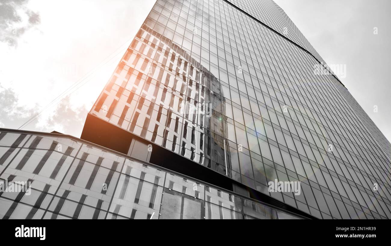 Bottom view of modern skyscraper in business district against blue sky ...