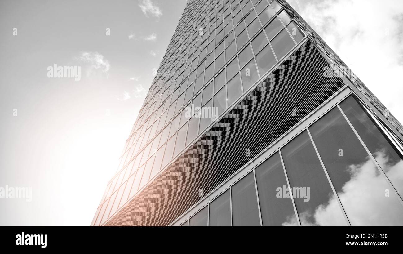 Bottom view of modern skyscraper in business district against blue sky ...