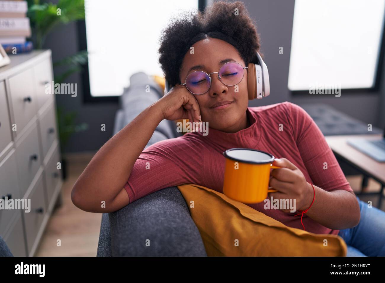 African american woman listening to music drinking coffee at home Stock ...