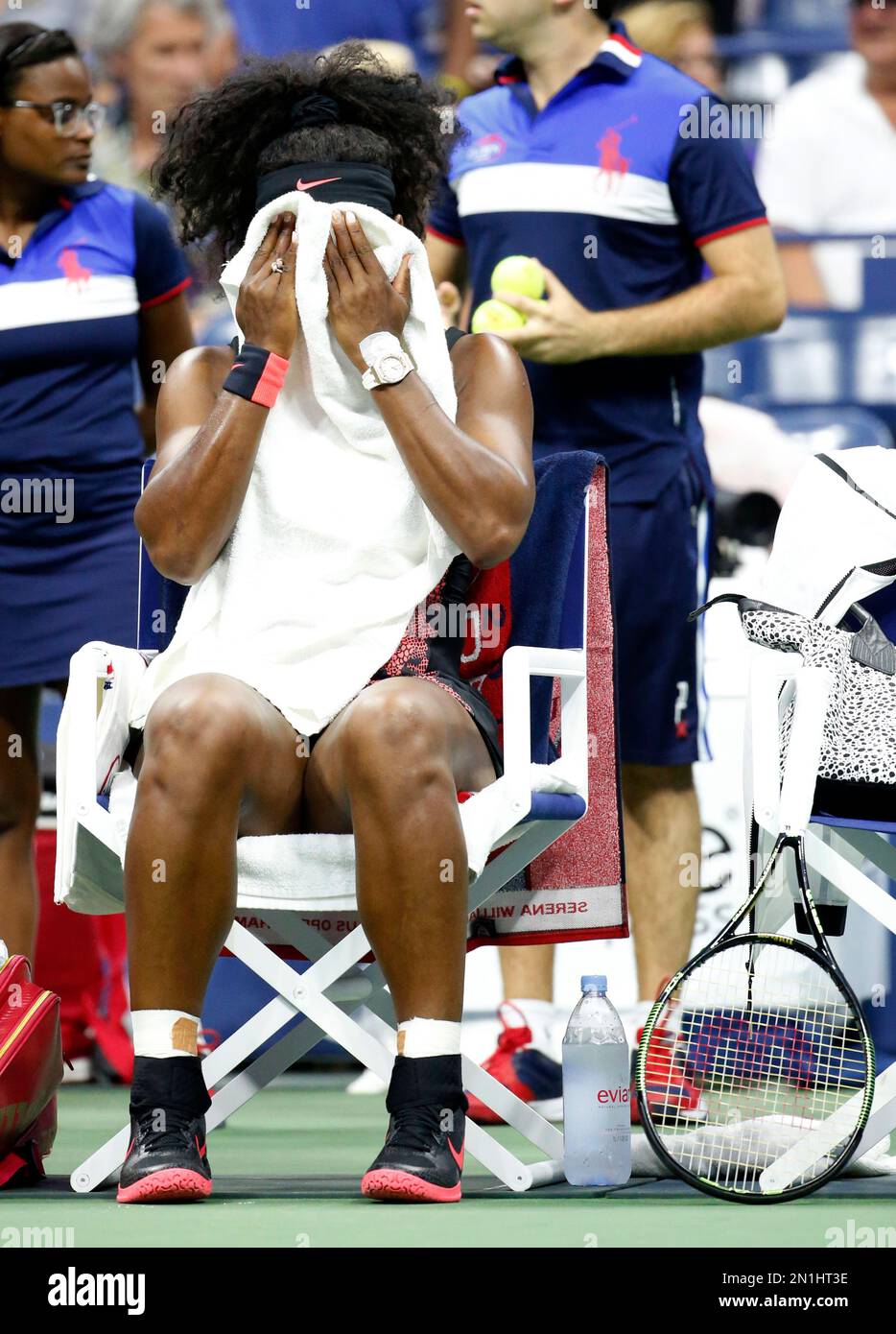Serena Williams, of the United States, wipes sweat after falling 3-0 in ...