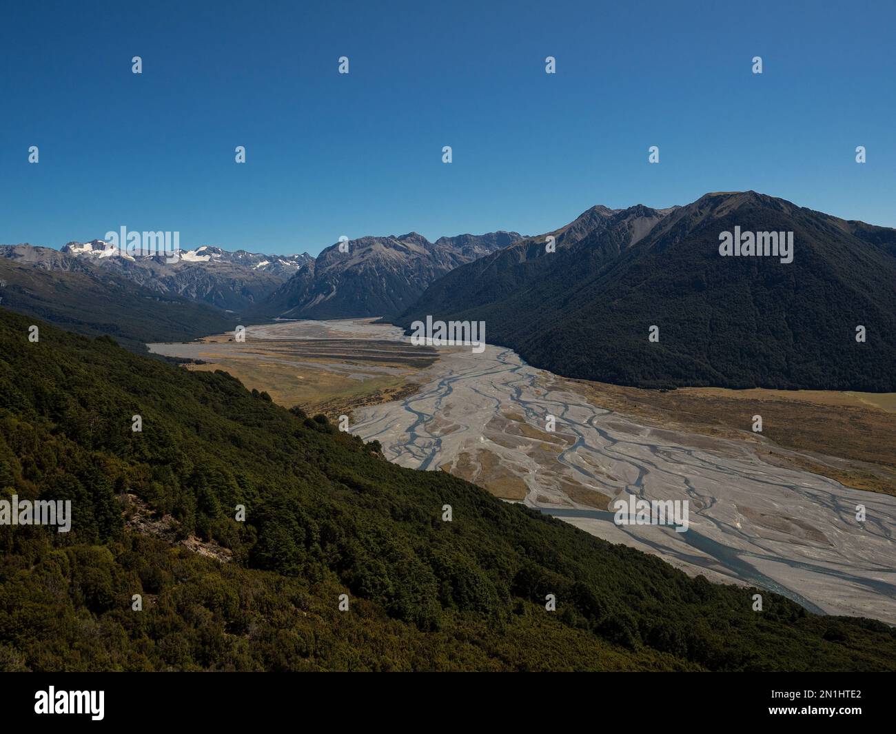 Alpine mountain valley panorama landscape with braided river ...