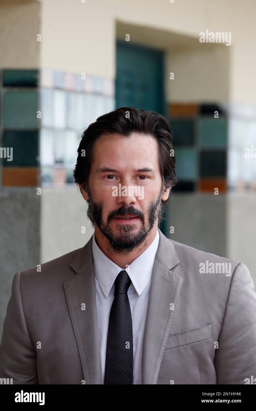 Keanu Reeves poses in front of beach huts, on the Deauville promenade ...