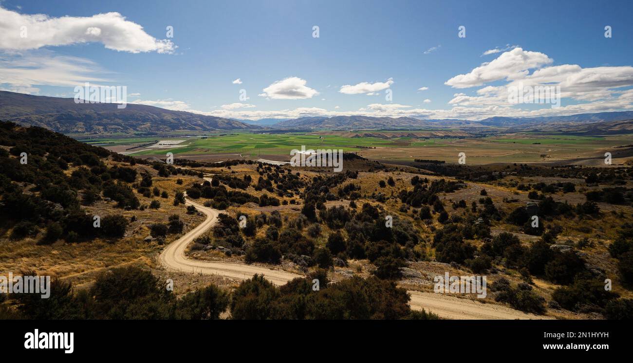 Backcountry nature panorama of road winding through dry rural landscape ...