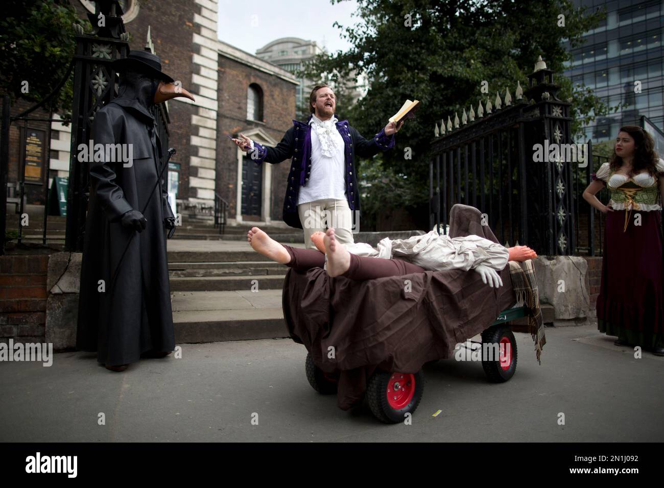 A reenactment actor dressed up as author Daniel Defoe stands next to a ...