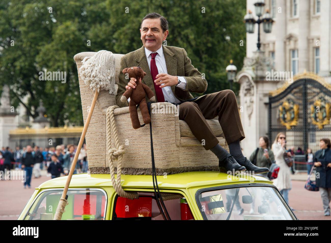 British actor Rowan Atkinson, dressed as Mr Bean, sits on top of a Mini ...