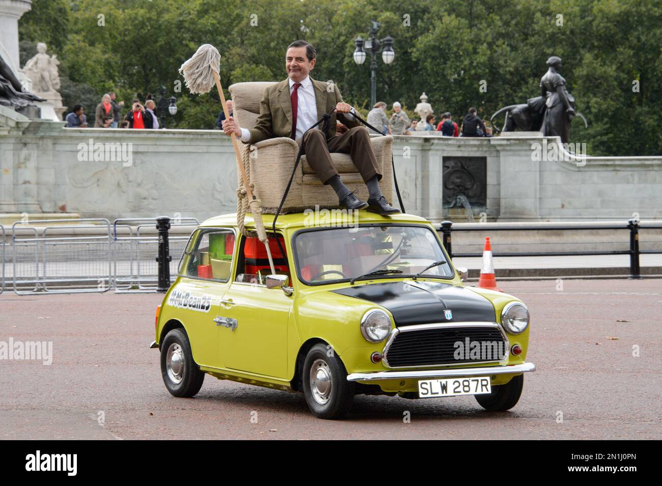 British actor Rowan Atkinson, dressed as Mr Bean, sits on top of a Mini ...