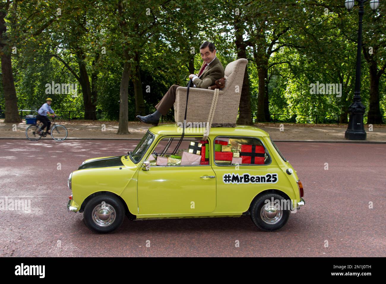 British actor Rowan Atkinson, dressed as Mr Bean drives down the Mall ...