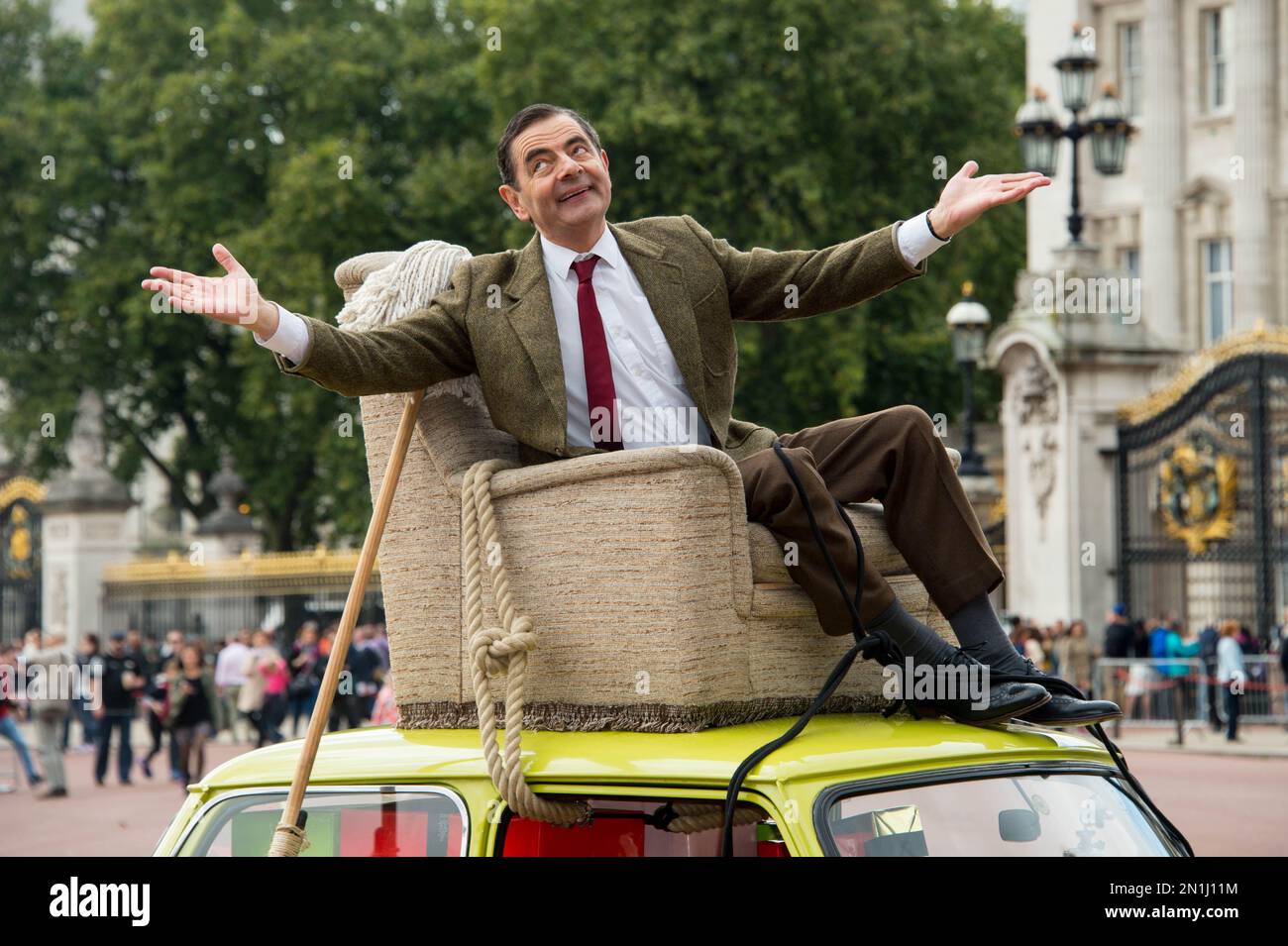 British actor Rowan Atkinson, dressed as Mr Bean, sits on top of a Mini ...