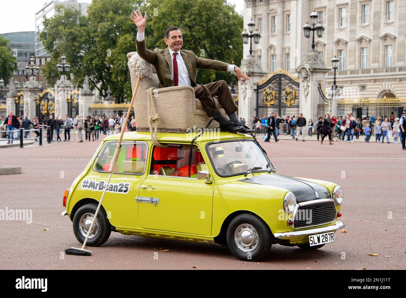 British actor Rowan Atkinson, dressed as Mr Bean, sits on top of a Mini ...