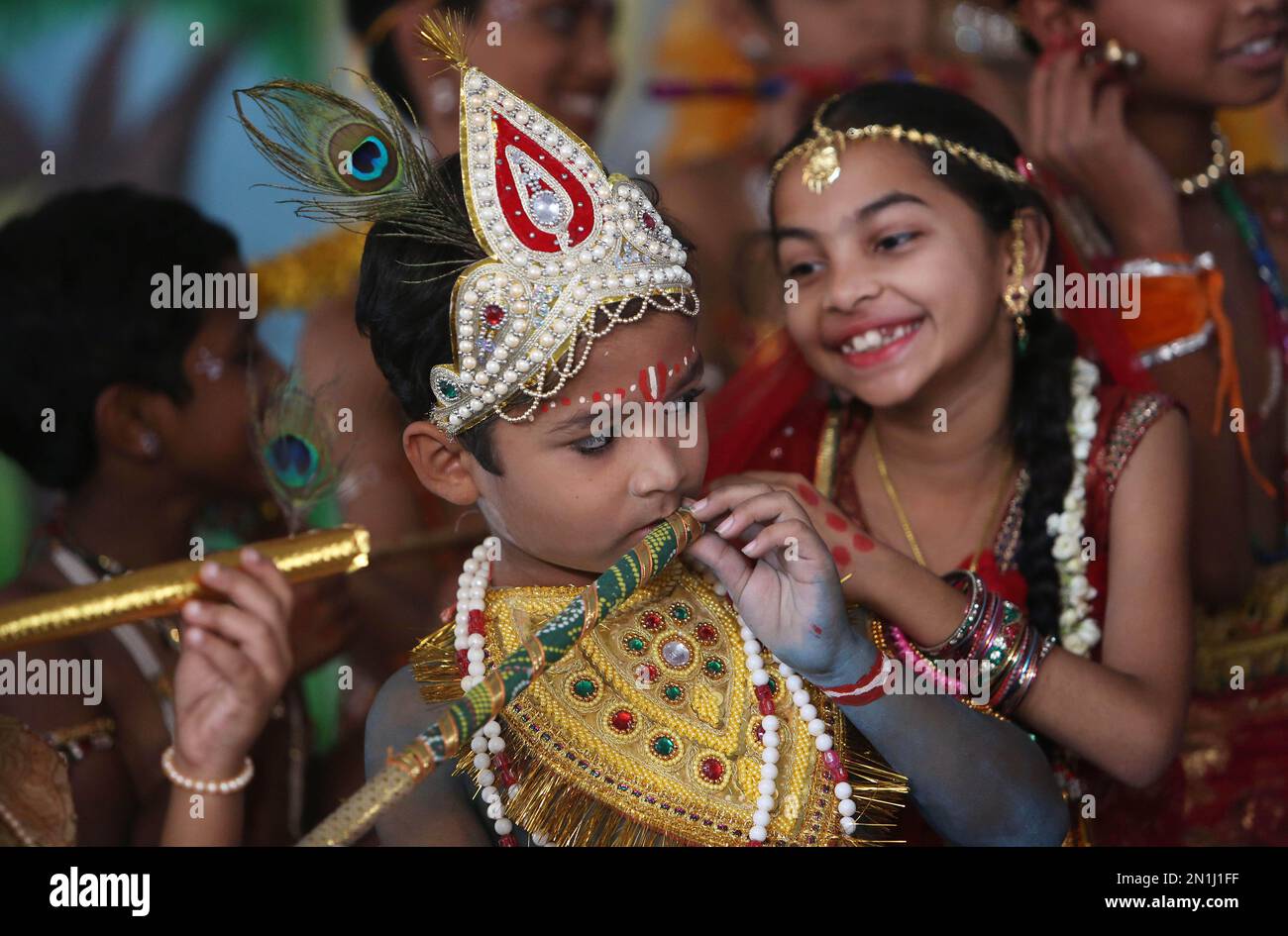 Indian school children dressed as Hindu God Krishna and his consort ...