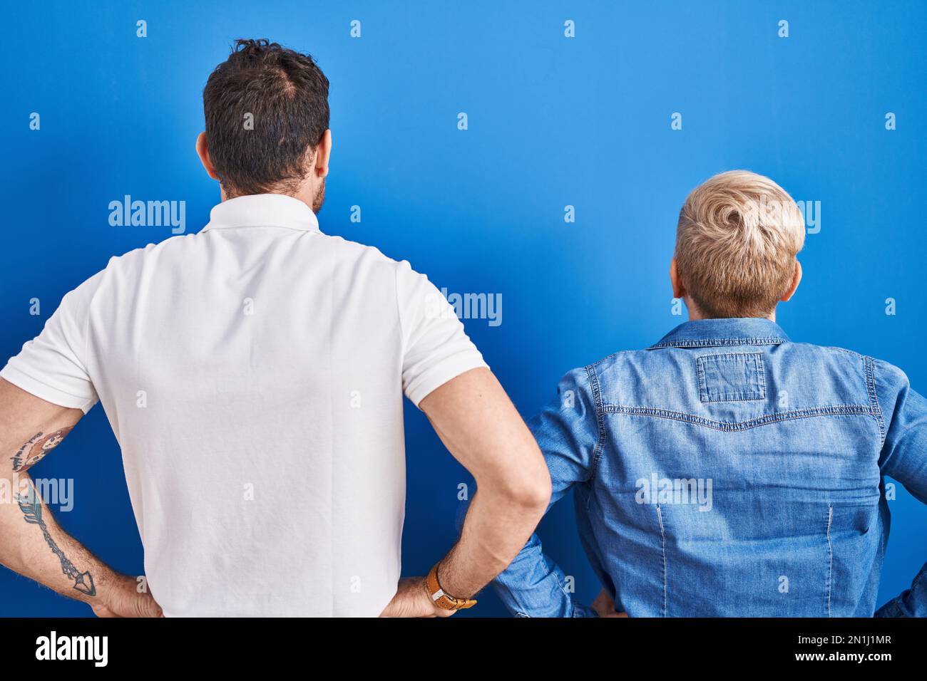 Young brazilian mother and son standing over blue background standing ...