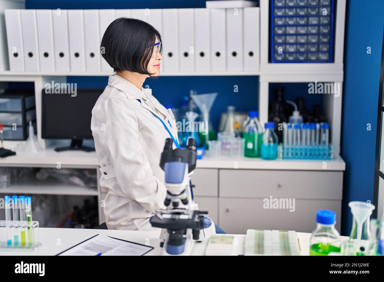 Young asian woman working at scientist laboratory looking to side ...