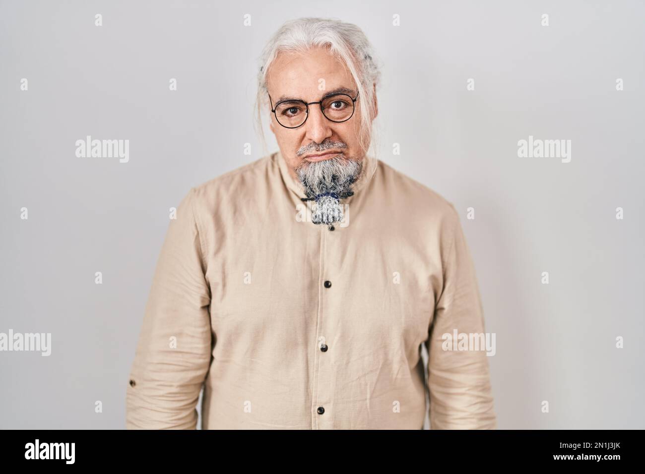 Middle age man with grey hair standing over isolated background ...