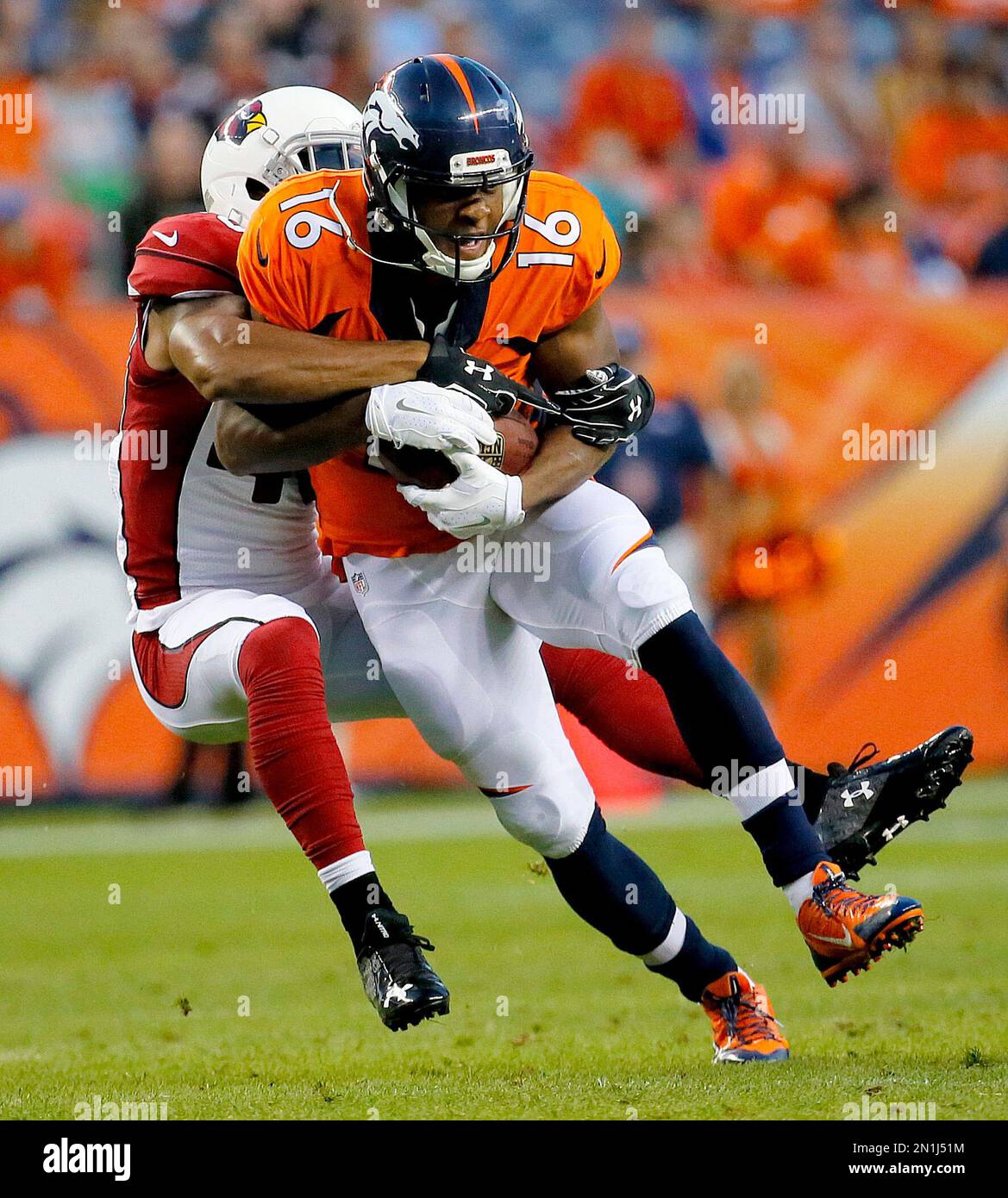 Denver Broncos wide receiver Bennie Fowler (16) is hit by Arizona ...