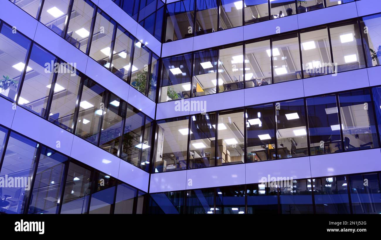 Pattern of office buildings windows illuminated at night. Lighting with ...
