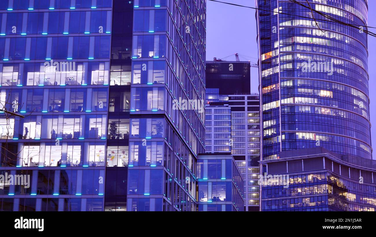 Pattern of office buildings windows illuminated at night. Lighting with ...