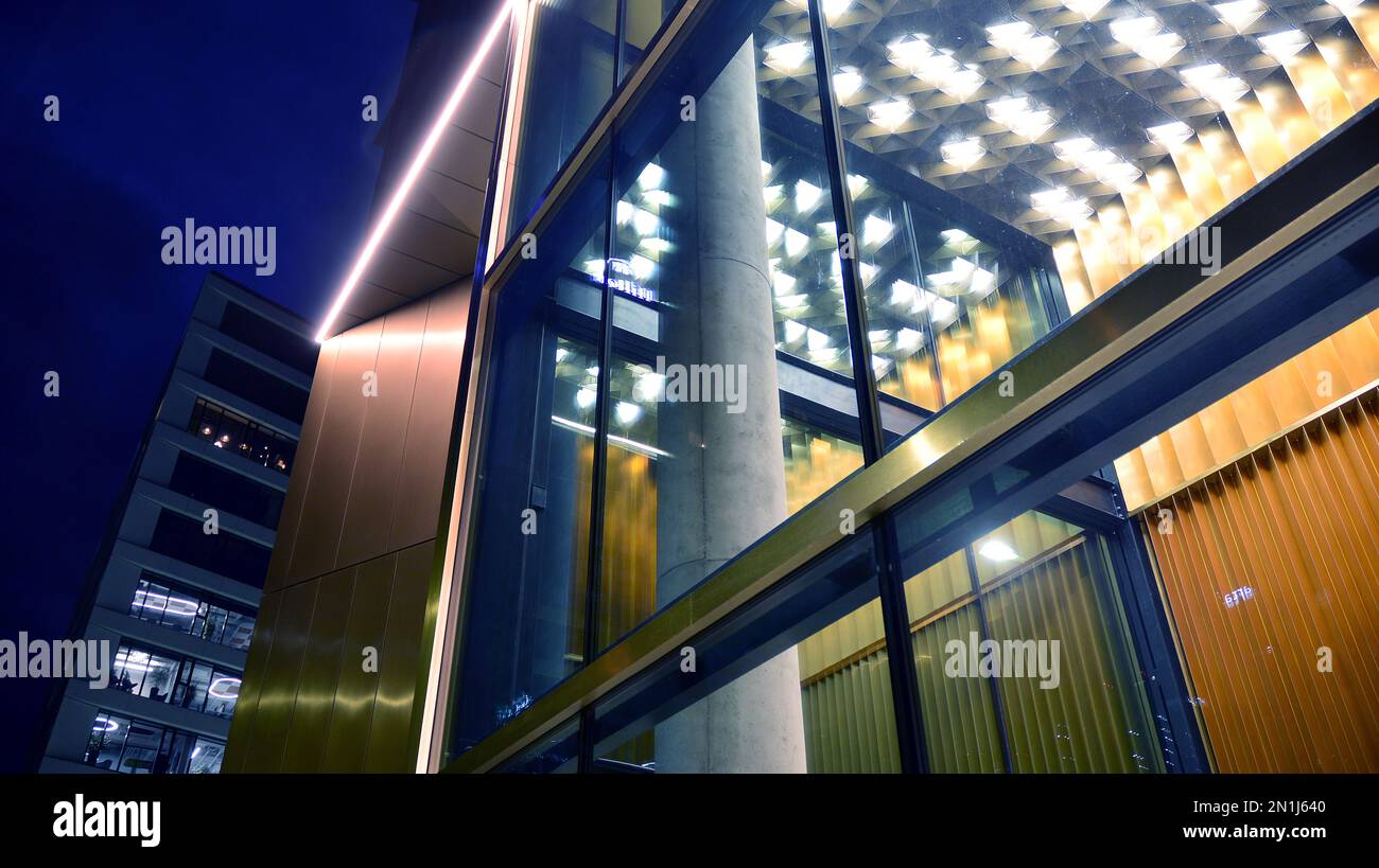 Pattern of office buildings windows illuminated at night. Lighting with ...