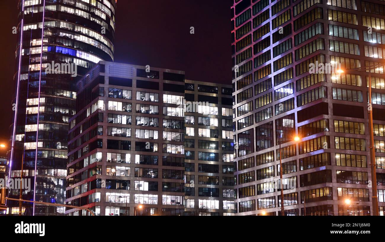 Pattern of office buildings windows illuminated at night. Lighting with ...