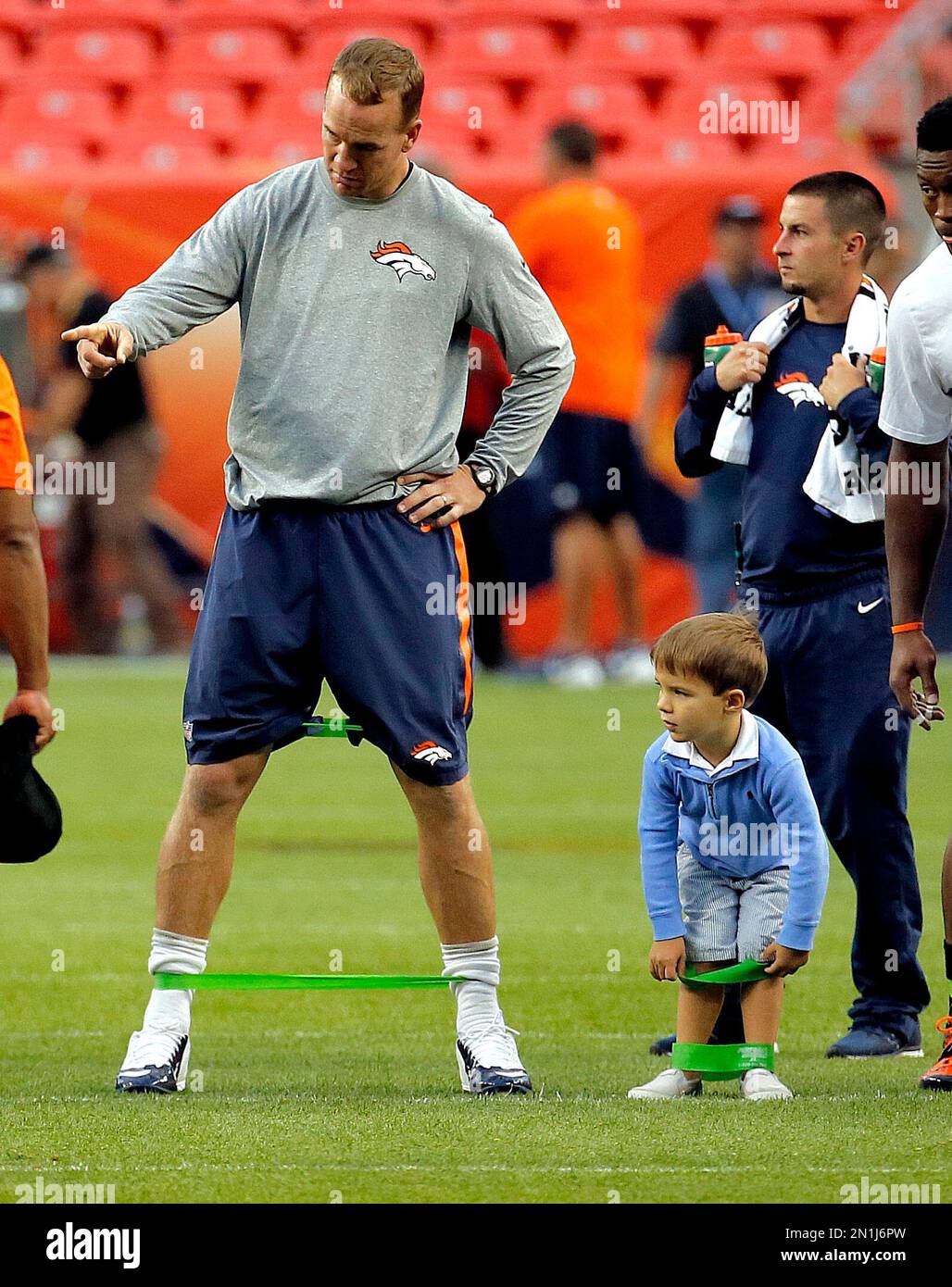Denver Broncos quarterback Peyton Manning stretches with his son ...