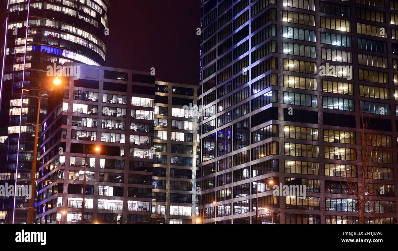 Pattern of office buildings windows illuminated at night. Lighting with ...