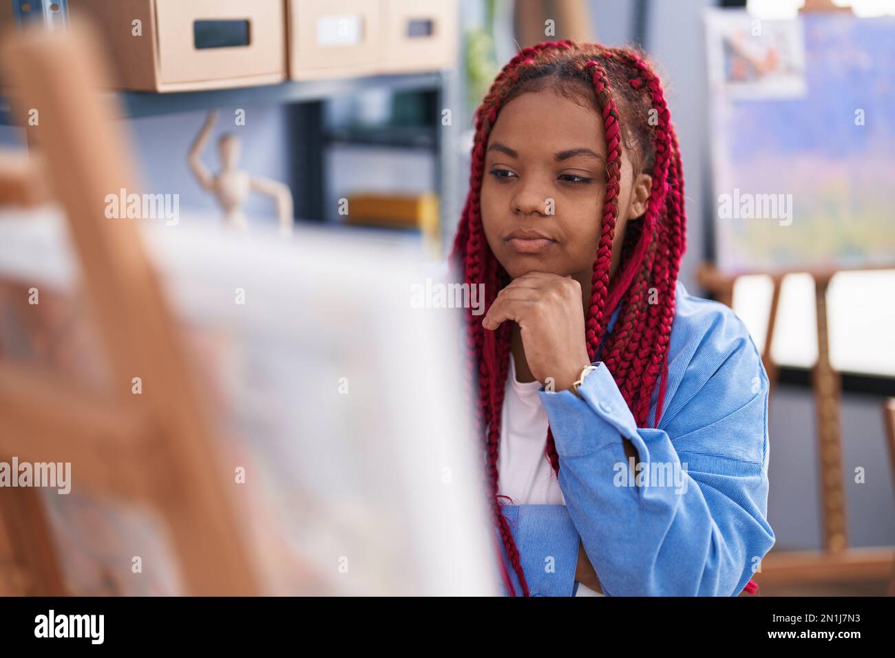 African american woman artist looking draw with doubt expression at art ...