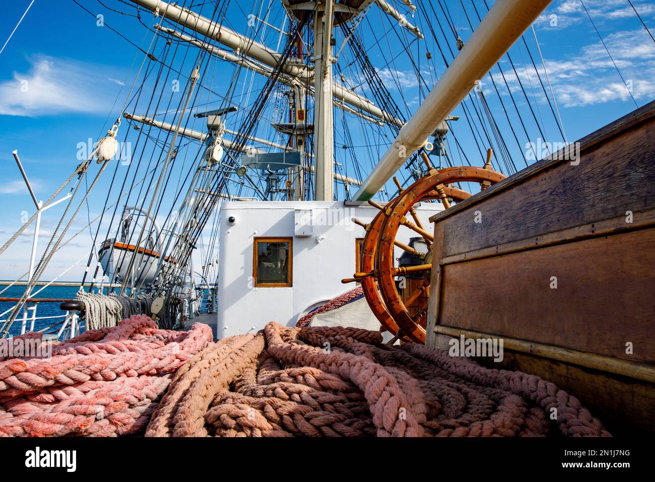 Sailship deck with helm, rigging and cables Stock Photo - Alamy