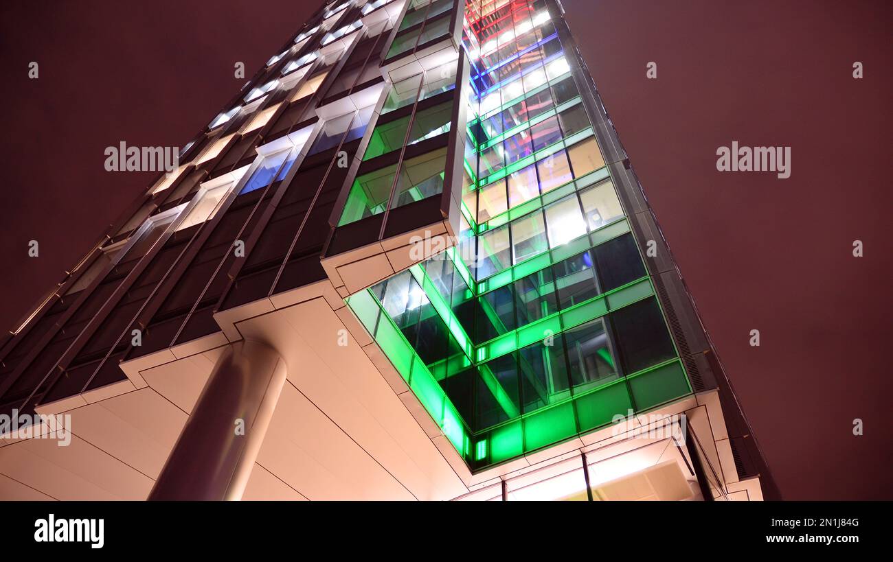 Pattern of office buildings windows illuminated at night. Lighting with ...