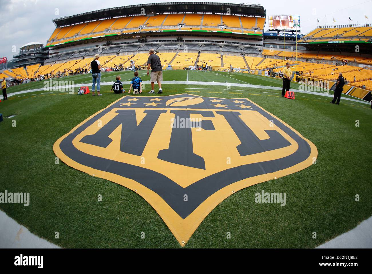 Gold NFL logos are on the sideline during warmup before an NFL football ...