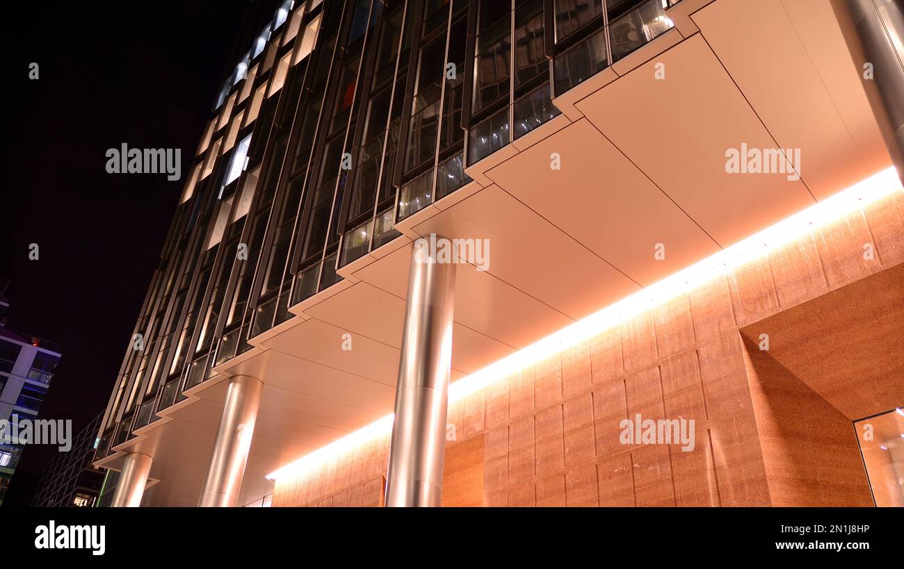 Pattern of office buildings windows illuminated at night. Lighting with ...