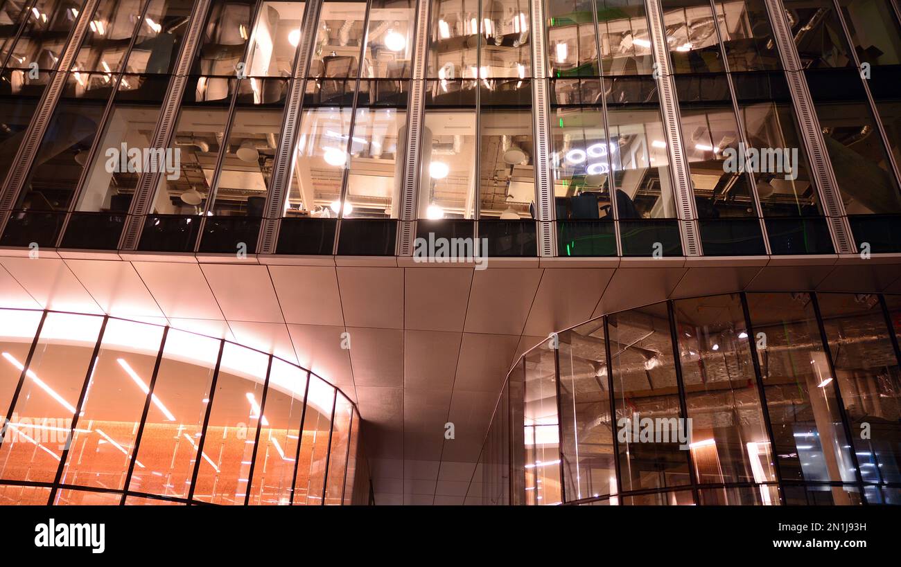 Pattern of office buildings windows illuminated at night. Lighting with ...