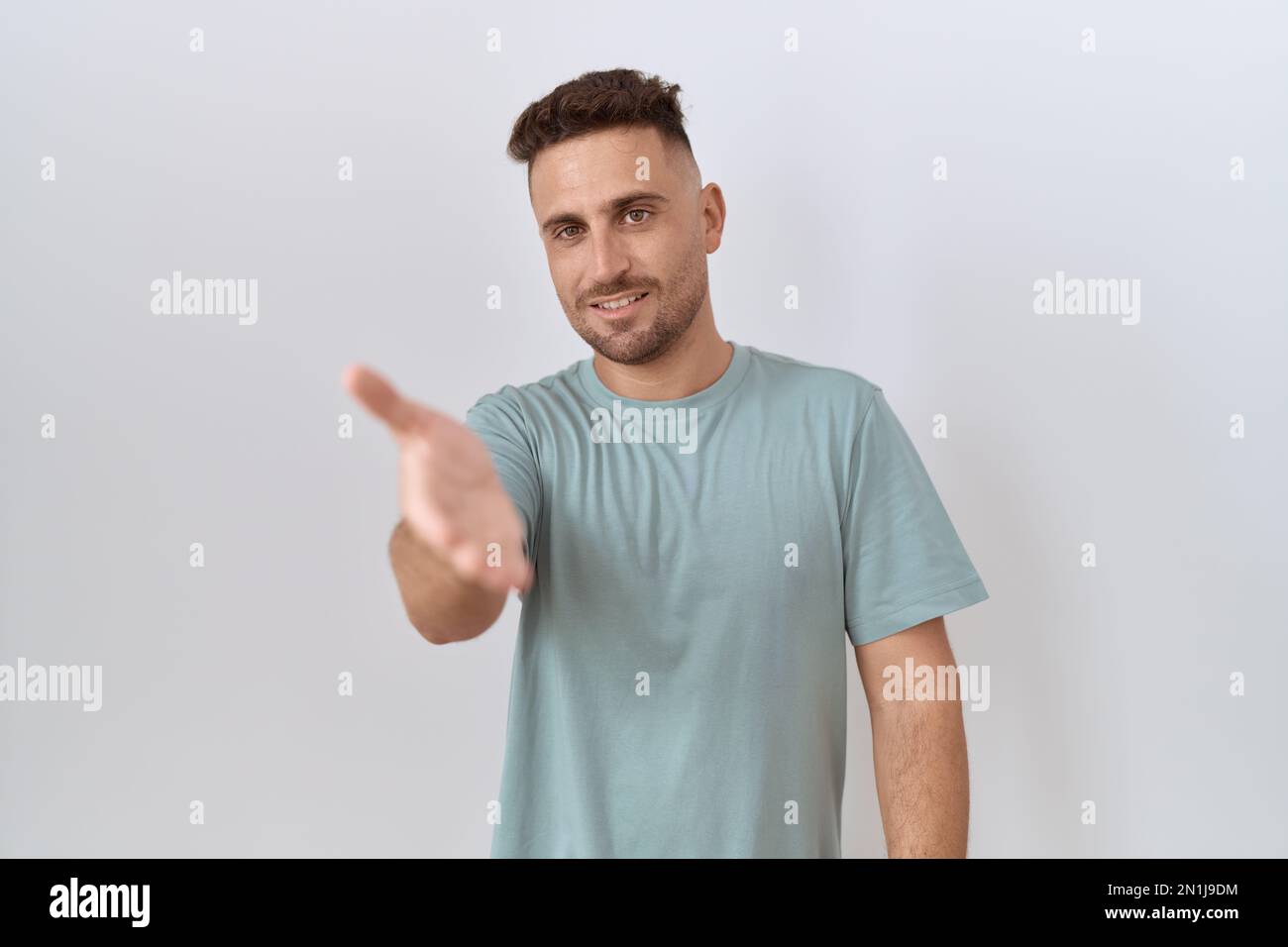 Hispanic man with beard standing over white background smiling cheerful ...