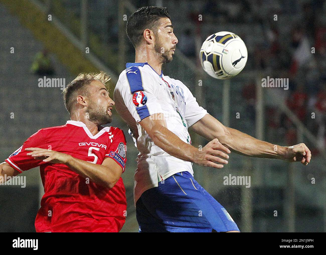 Malta's Andrei Agius, left, and Italy's Graziano Pelle' vie for the ...