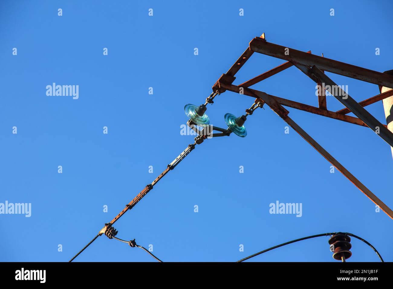 Electric pole with a linear wire against the blue sky close-up. Power ...