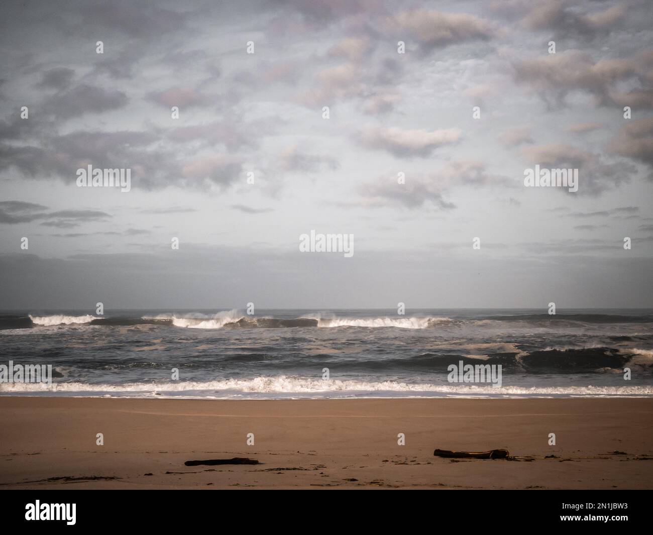 Atlantic Ocean on a pale winter day. Front view of waves at empty beach ...
