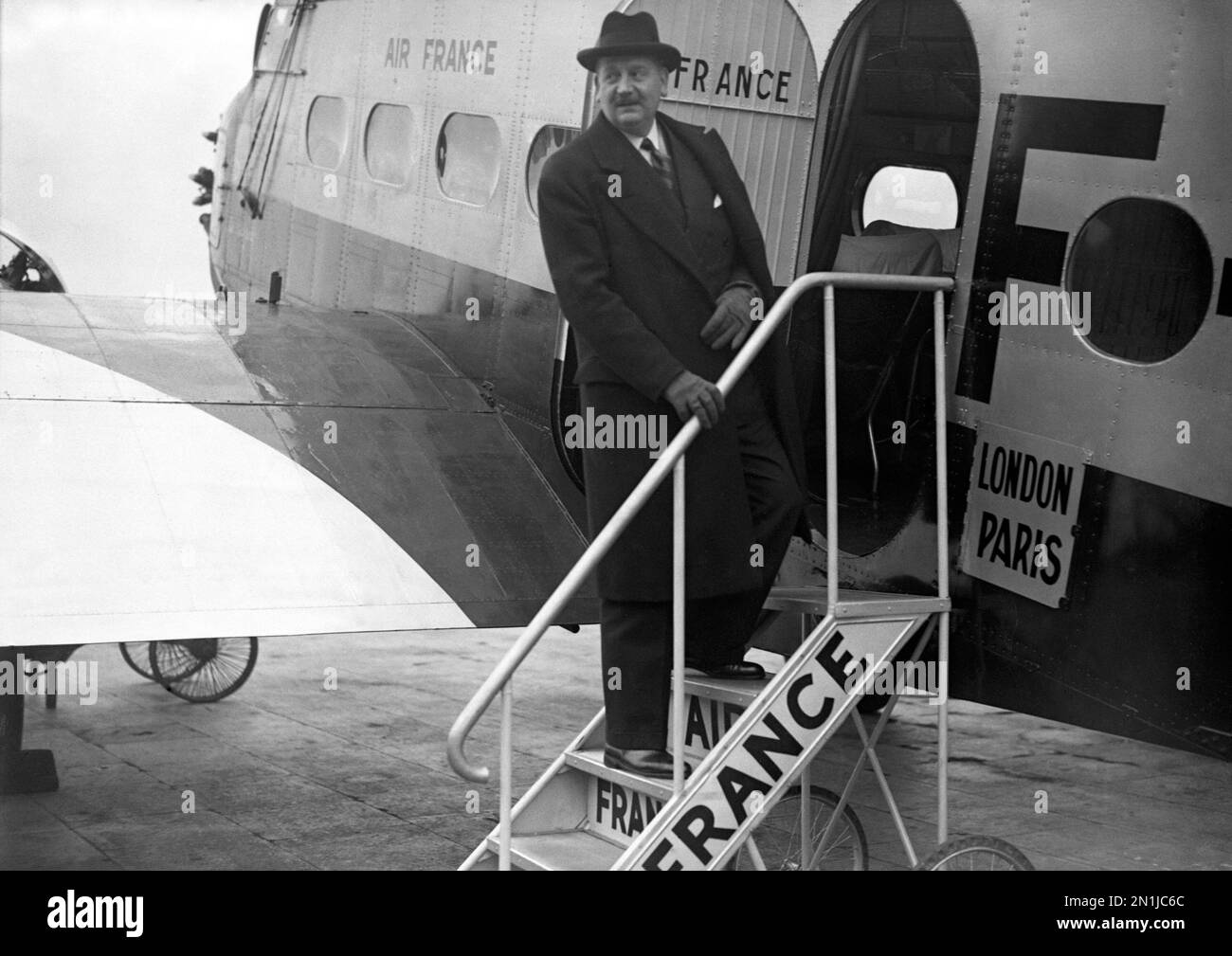 Pierre Etienne Flandin boarding the plane at Croydon, England on the ...