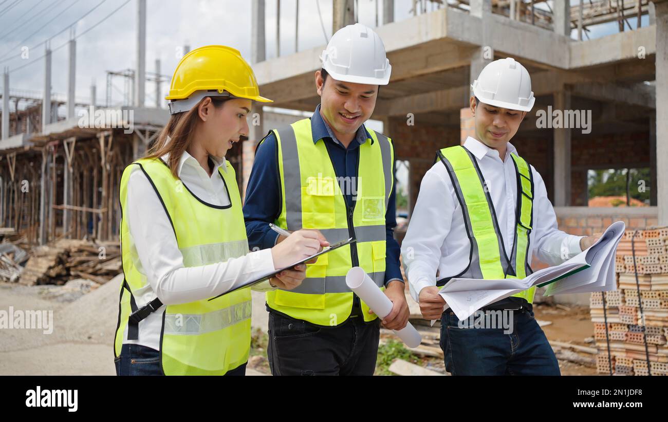 Asian Architector and engineers team with draft plan of building ...