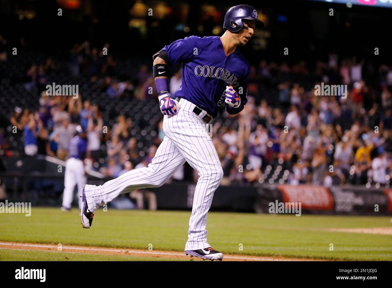 Colorado Rockies' Carlos Gonzalez reacts on his way around the bases ...