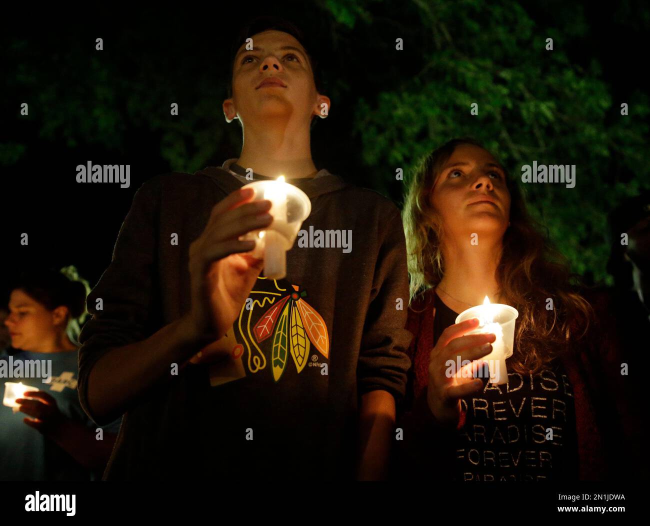 Nick Cichon, left, and his sister Val Cichon hold candle lights during ...