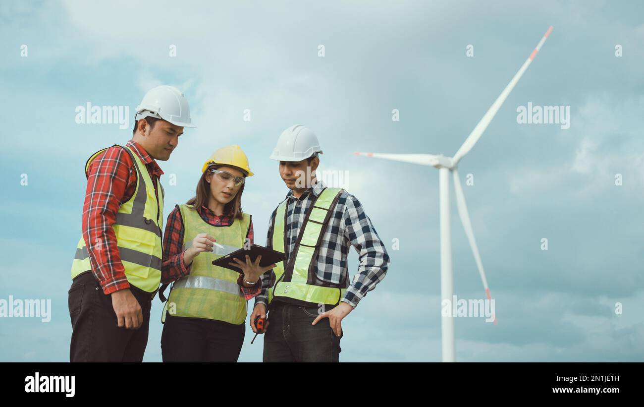 Team of asian engineers discussing and checking turbines on wind ...