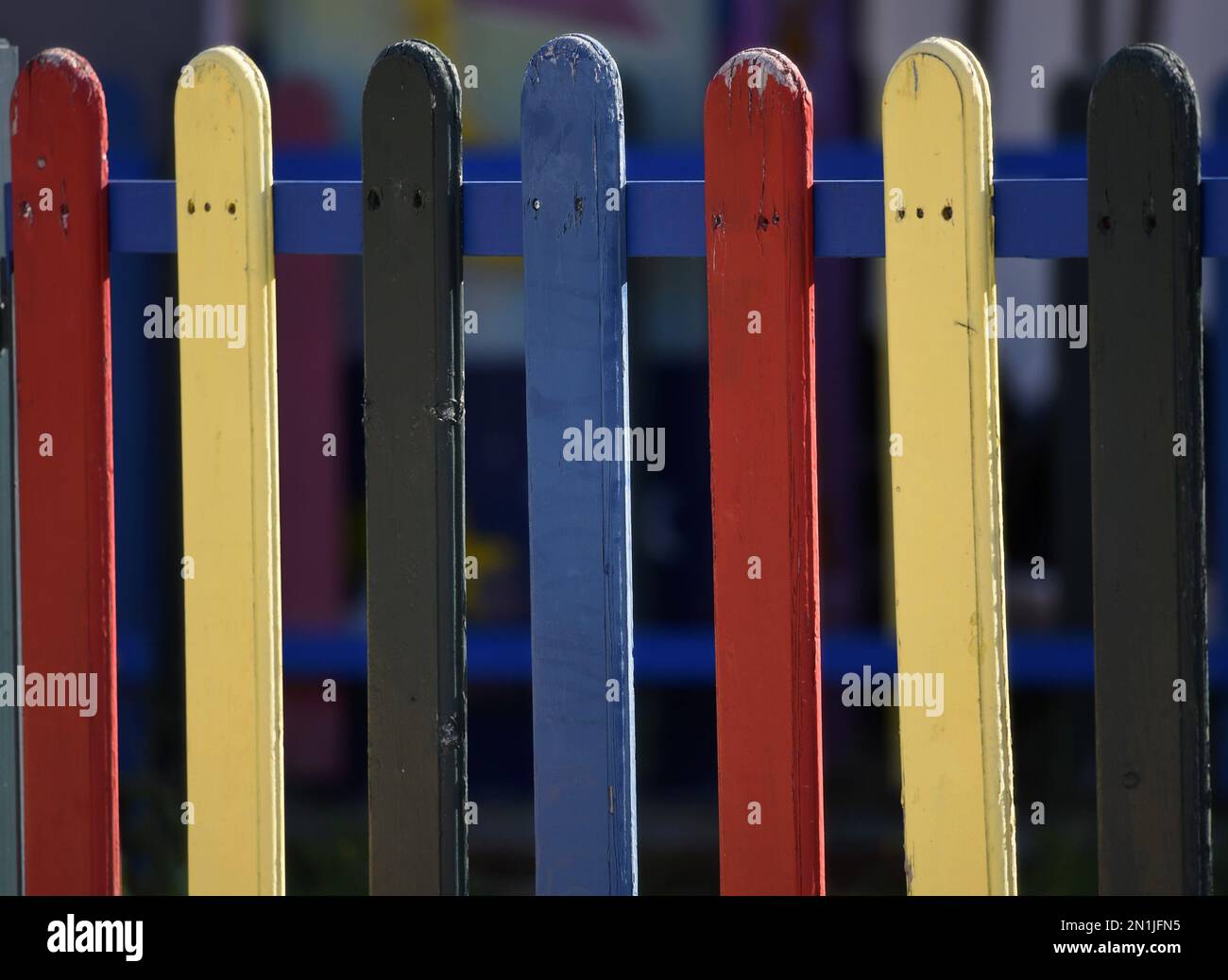 Outdoor playground colorful wooden picket fence Stock Photo - Alamy