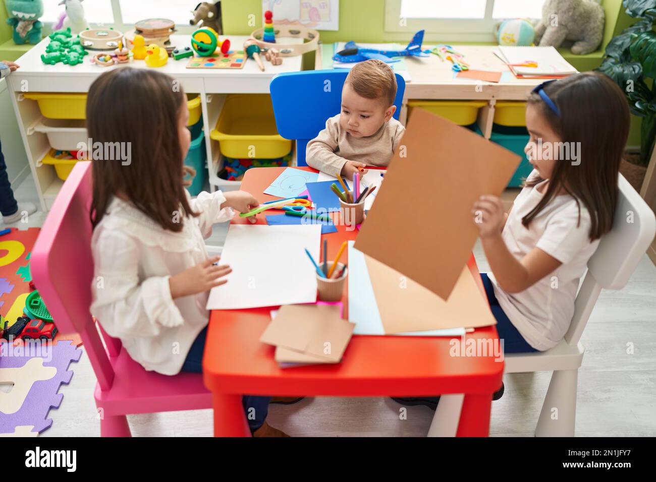 Group of kids preschool students sitting on table drawing and make ...