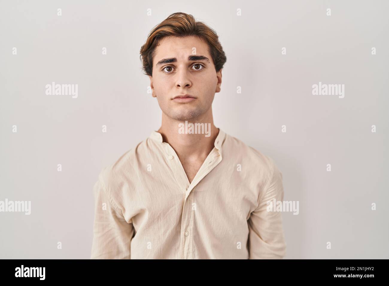 Young man standing over isolated background depressed and worry for ...