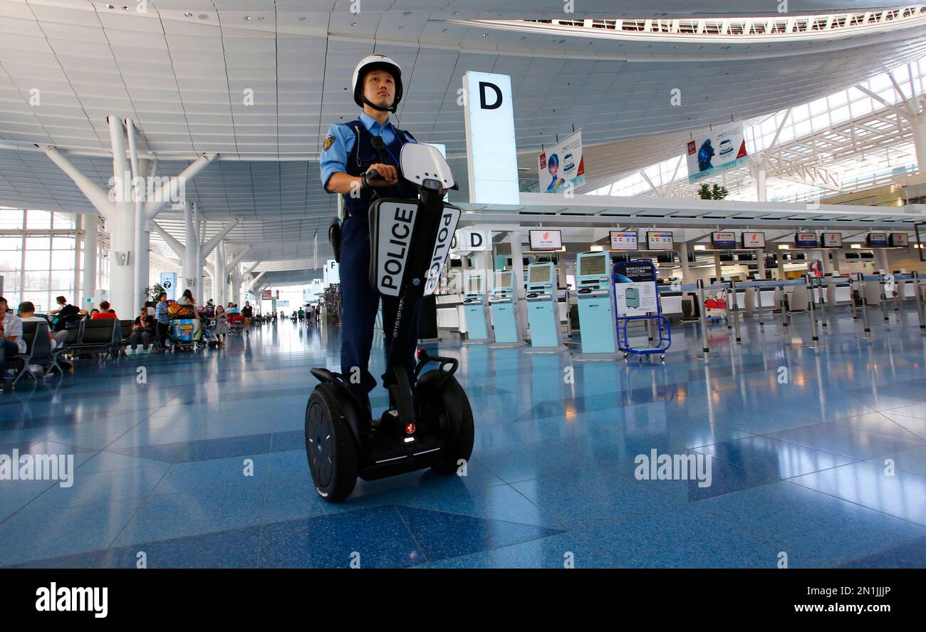 A police officer rides a Segway to patrol at Tokyo International ...