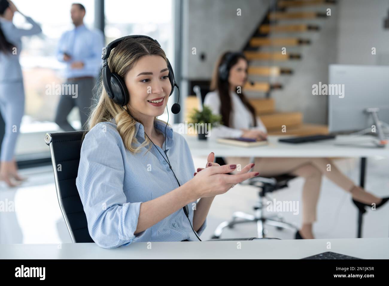 Beautiful business woman in headset working at customer service office ...