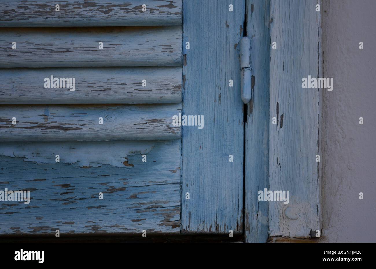 Old rural house light blue wooden window shutters with white trim on a ...