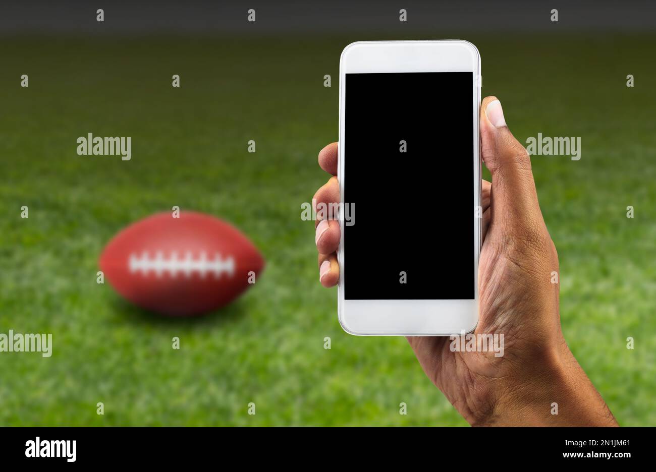 betting man through his smart phone in at stadium Stock Photo - Alamy