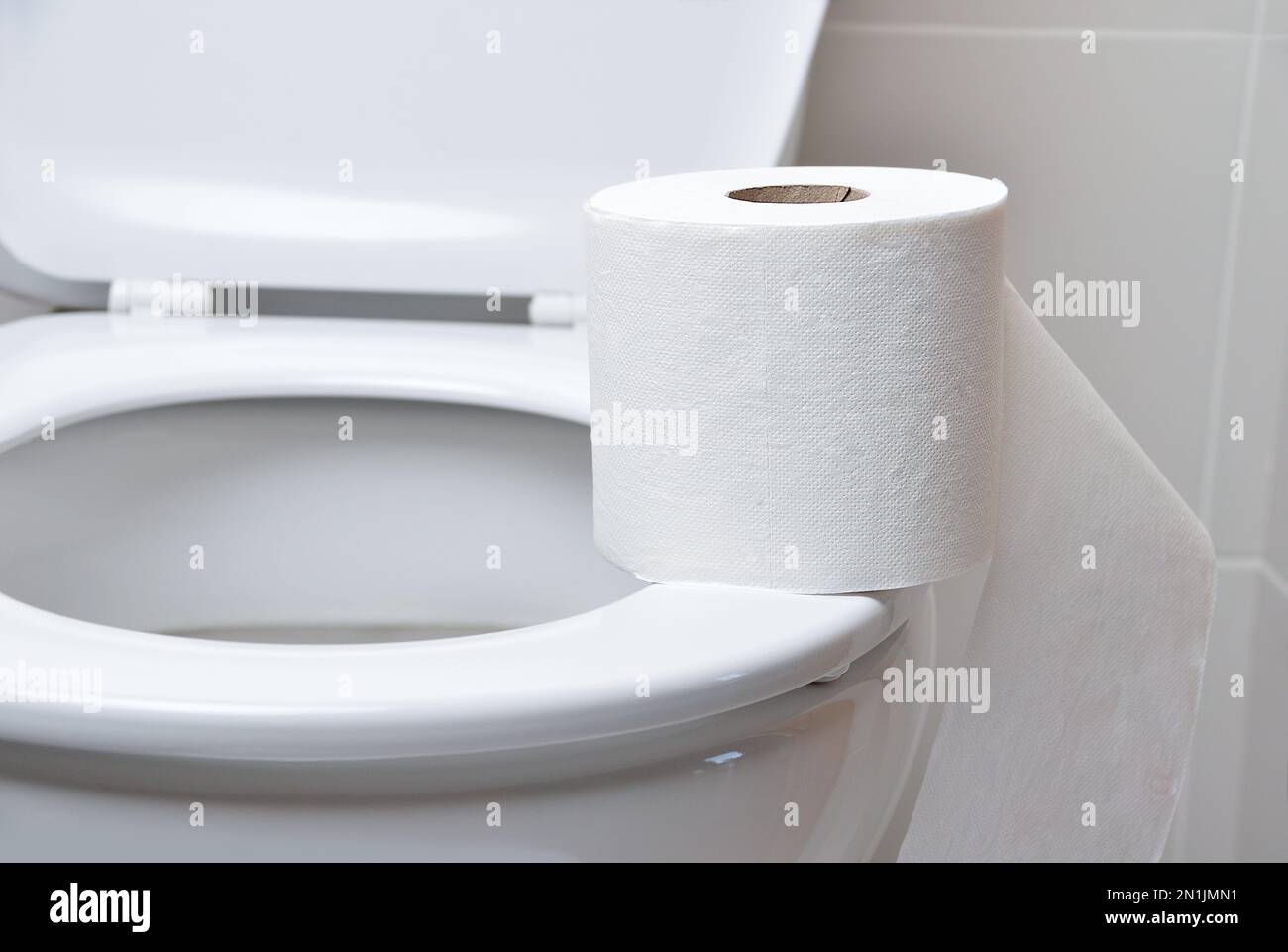Toilet paper on a toilet with the lid open Stock Photo - Alamy