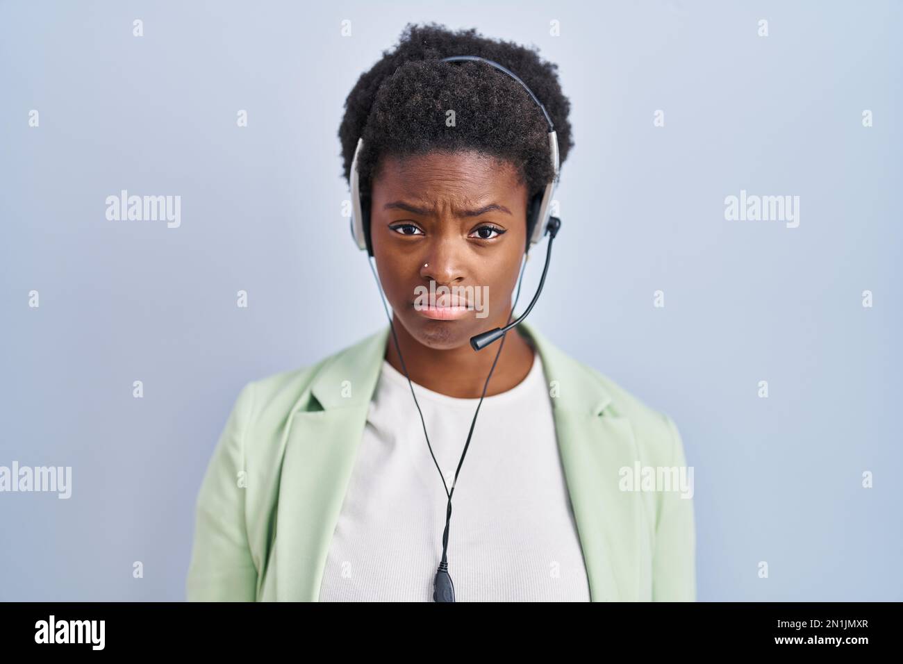 African american woman wearing call center agent headset depressed and ...